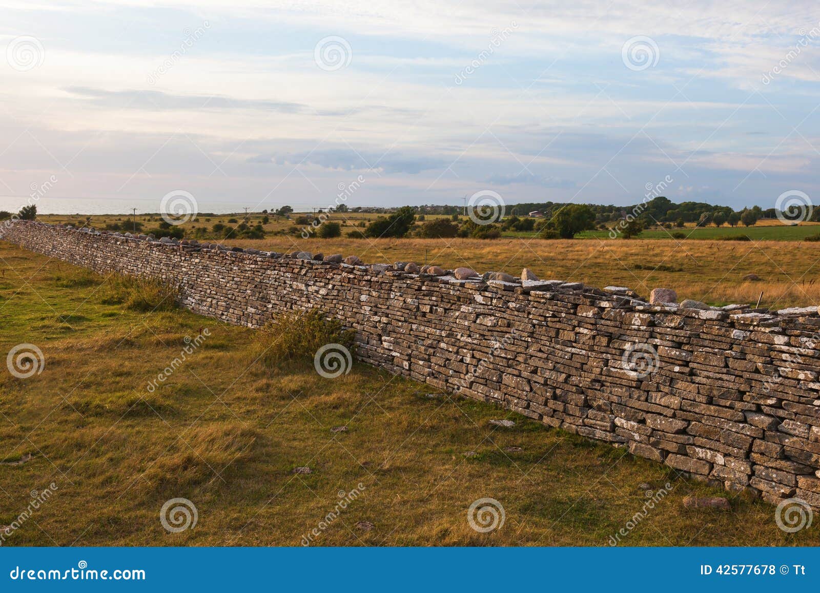 High stone wall in sunset stock photo. Image of field - 42577678