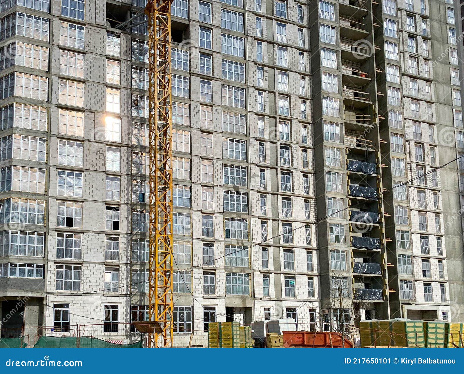 High Storey Building Under Construction with Tower Crane and Workers ...