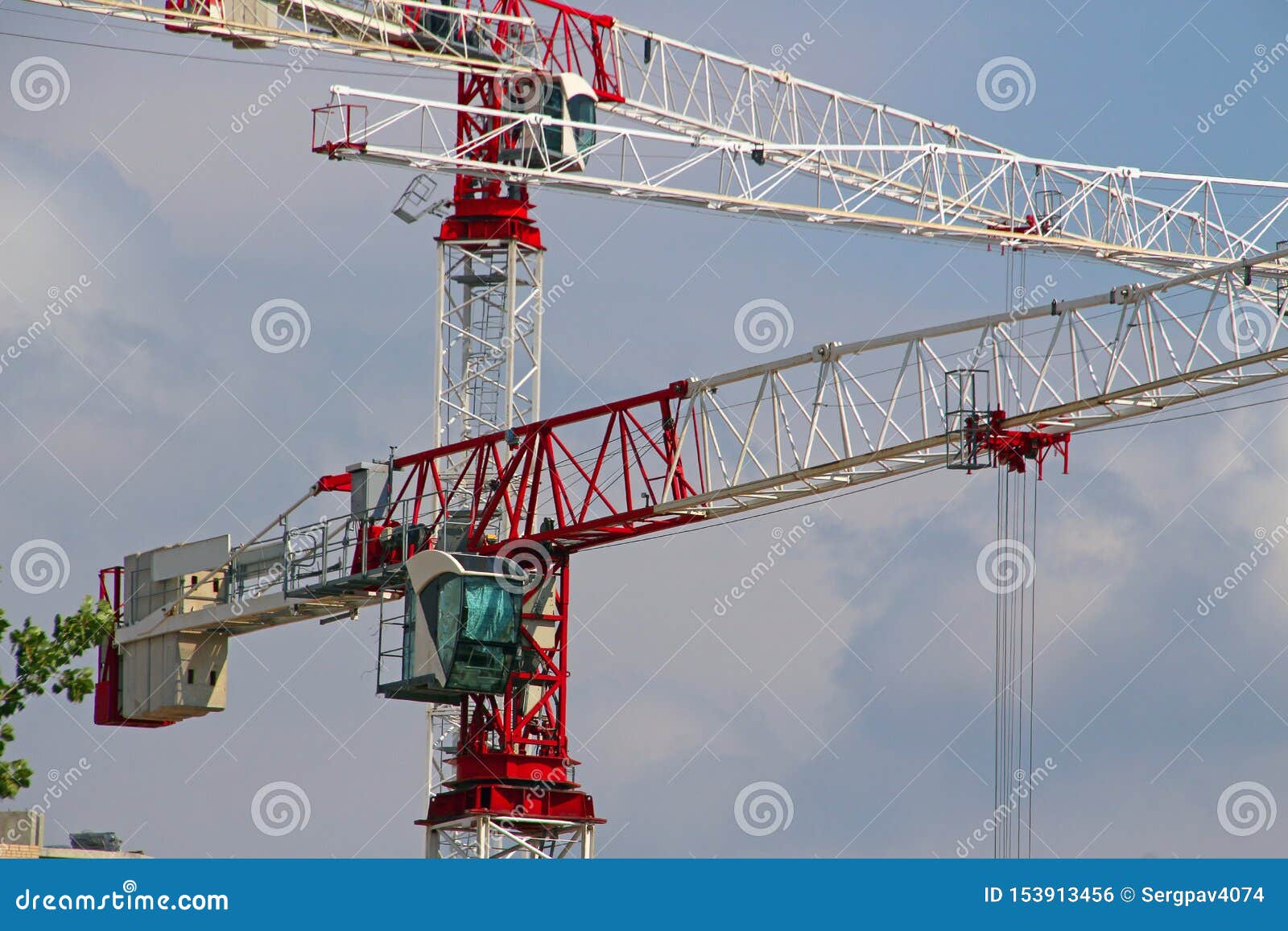 High Tower Cranes at a Construction Site Stock Photo - Image of loading ...