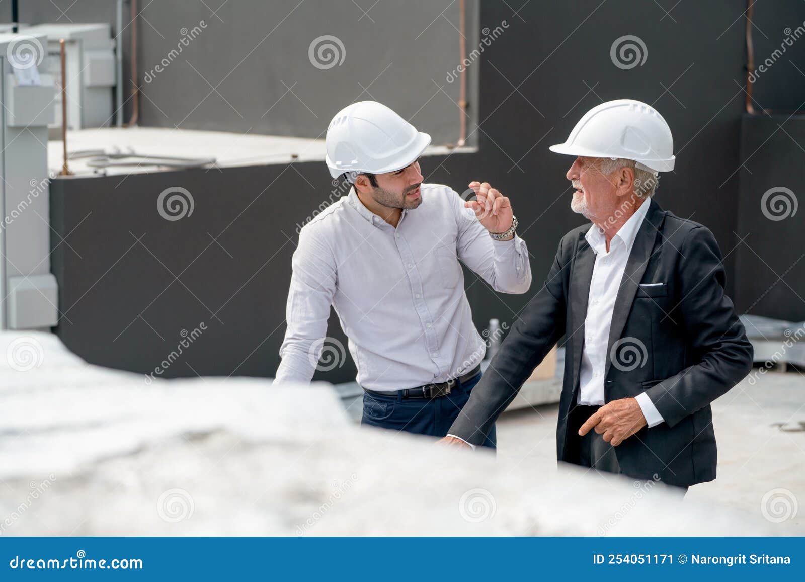 High View of Two Engineer or Technician Workers Discuss Together on ...