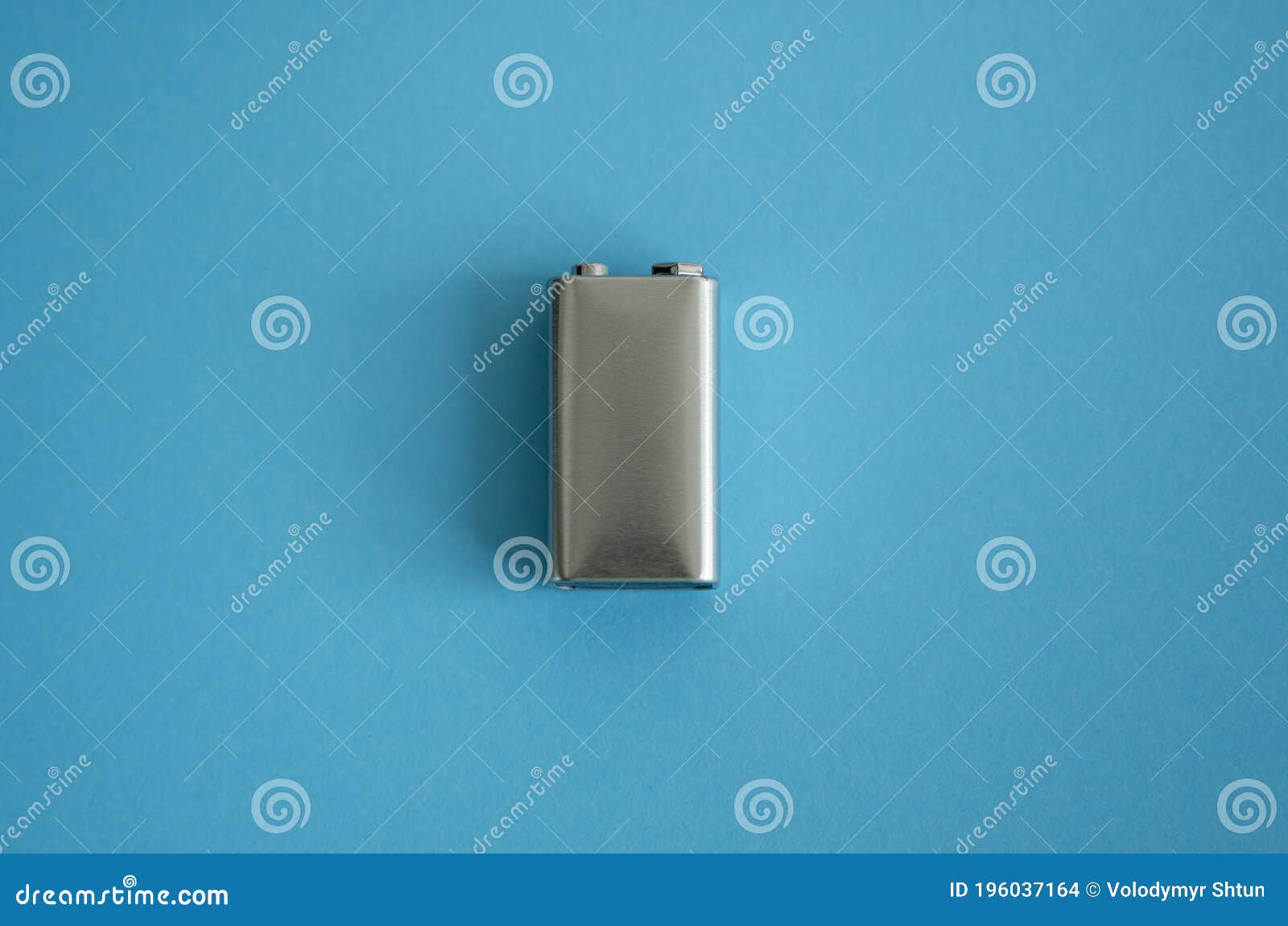 High Voltage Battery on a Blue Background. Silver Volt Battery. 9V ...