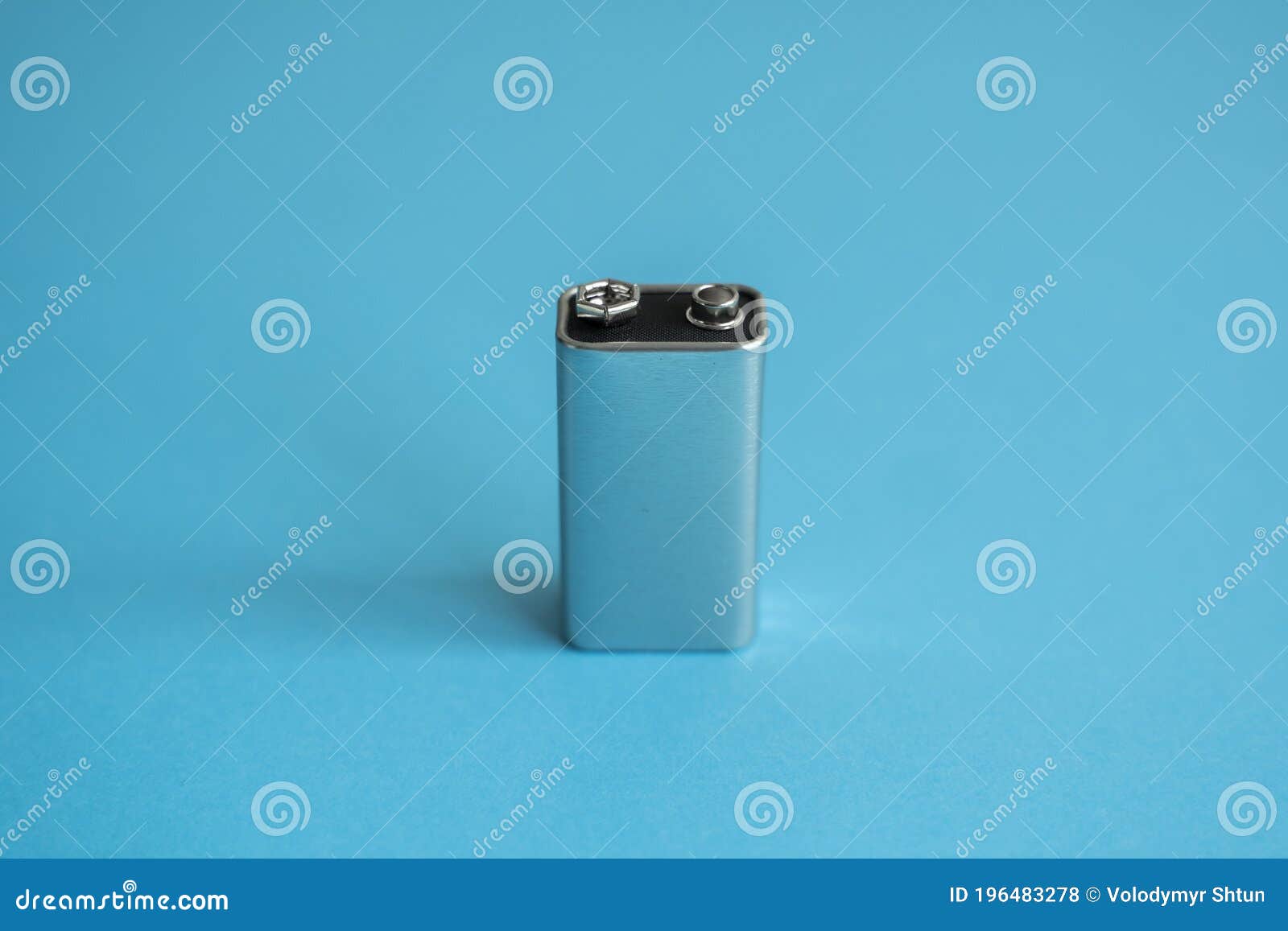 High Voltage Battery on a Blue Background. Silver Volt Battery. 9V ...