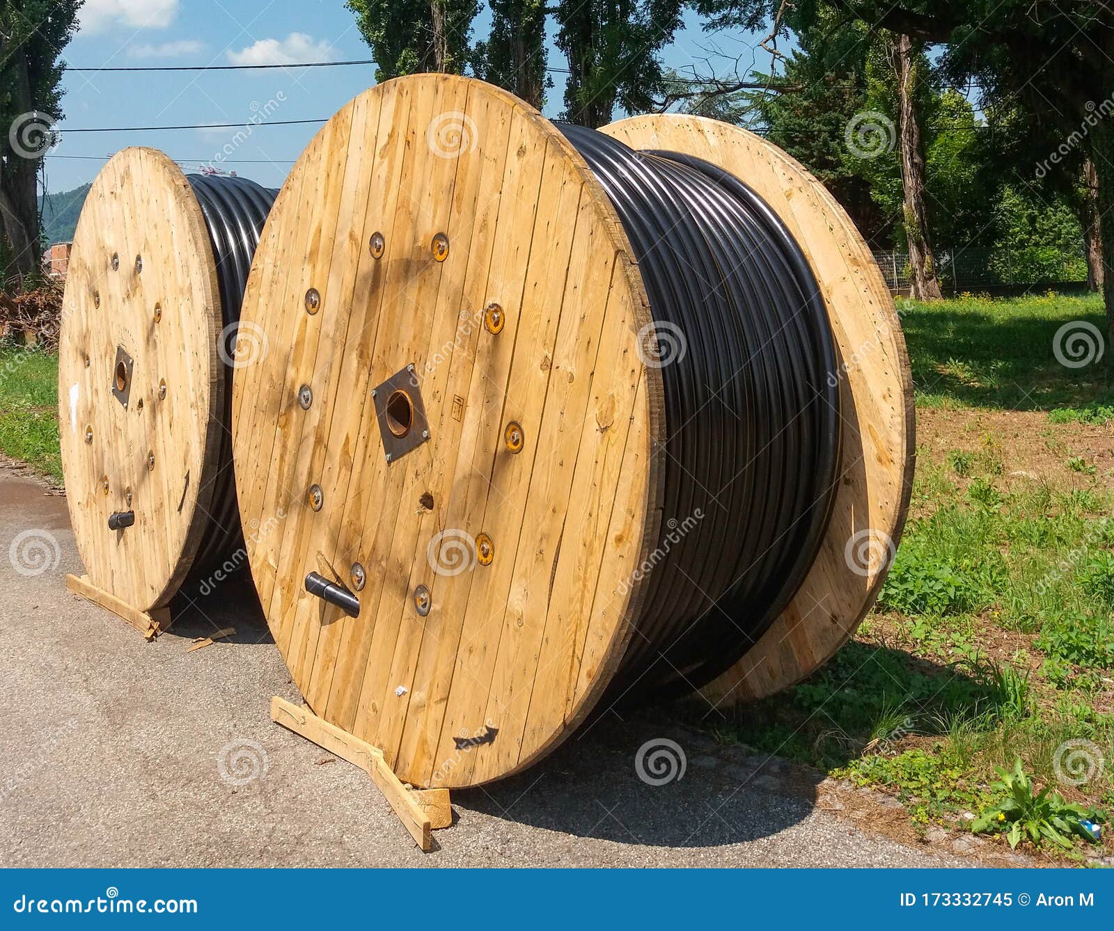 High Voltage Black Electrical Cable Rolled on Large Cable Reels Stock ...