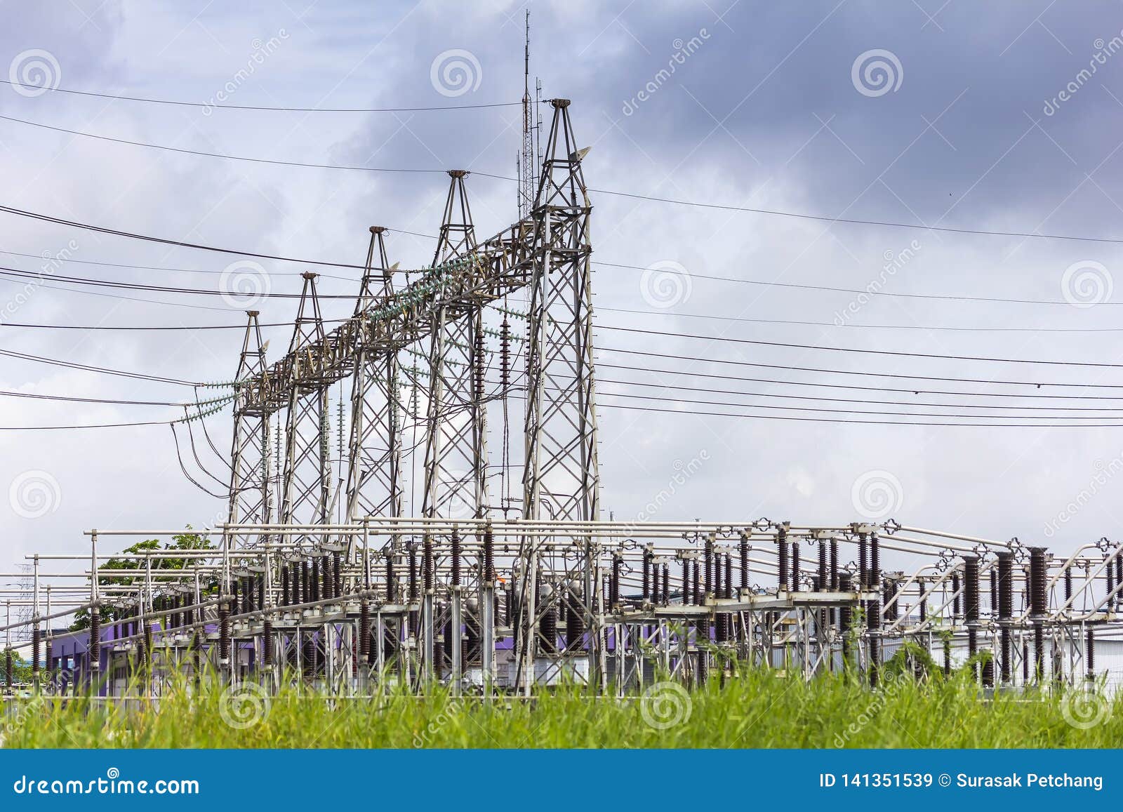 High Voltage Electric Power Substation with Cloudy Dark Sky Background ...