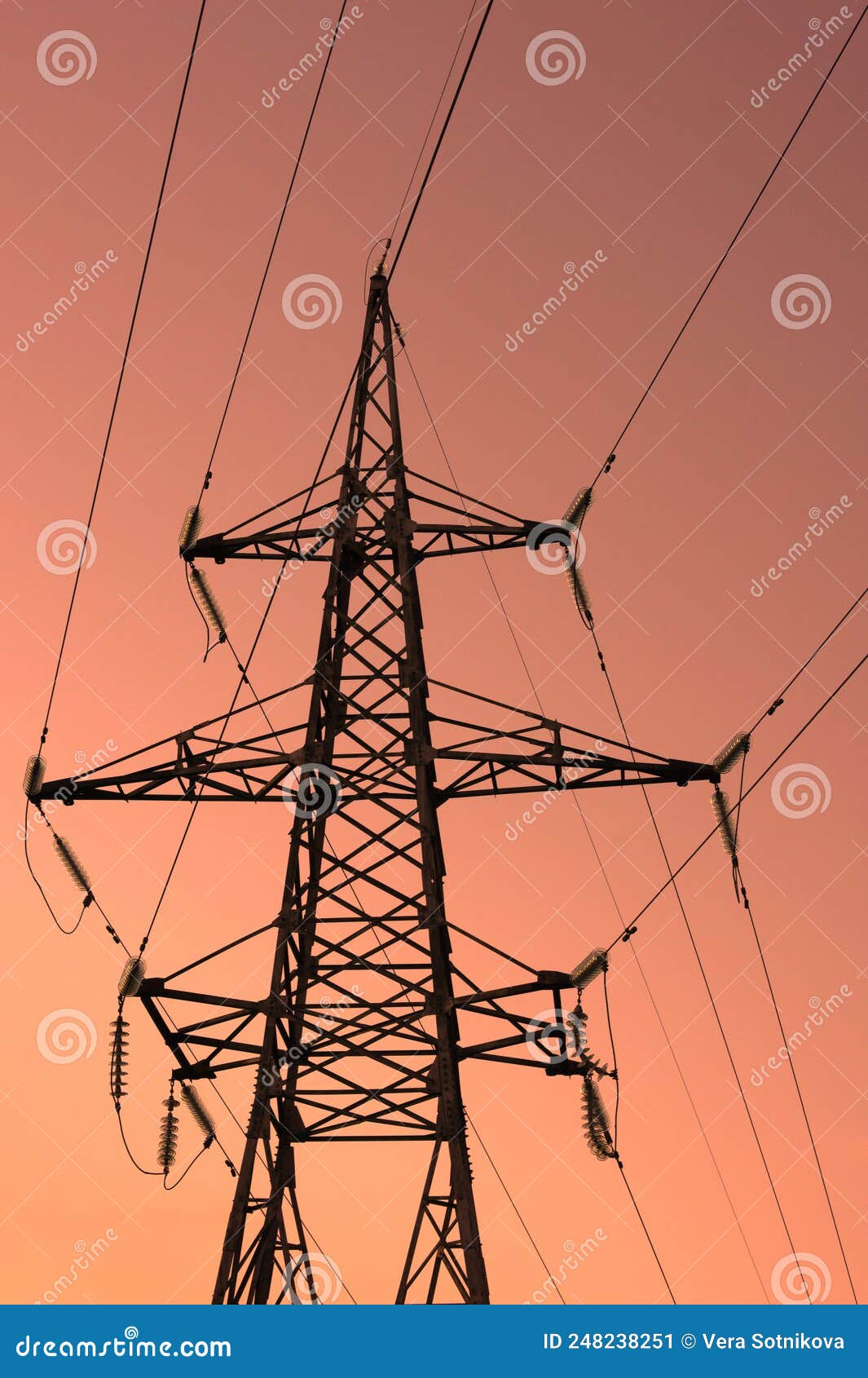 High Voltage Electric Tower Silhouette on Bright Orange Background ...