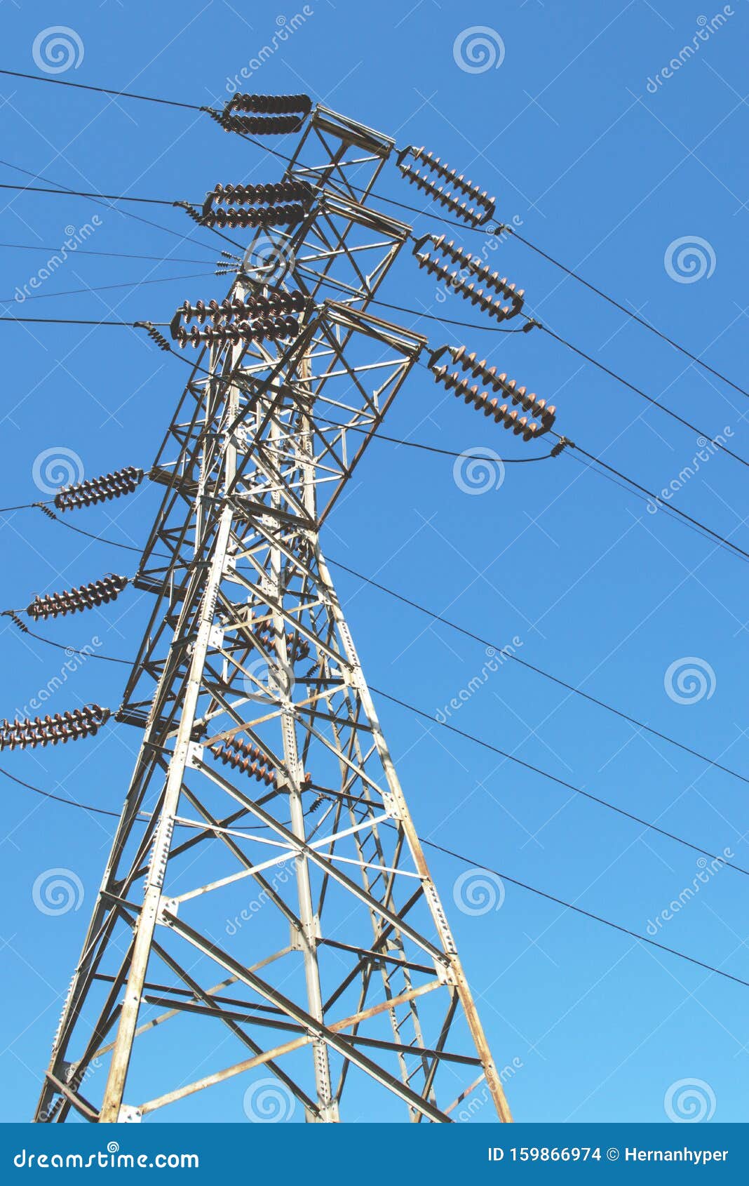 High Voltage Electrical Pylon. Low Angle Shot Against a Blue Sky. Stock ...