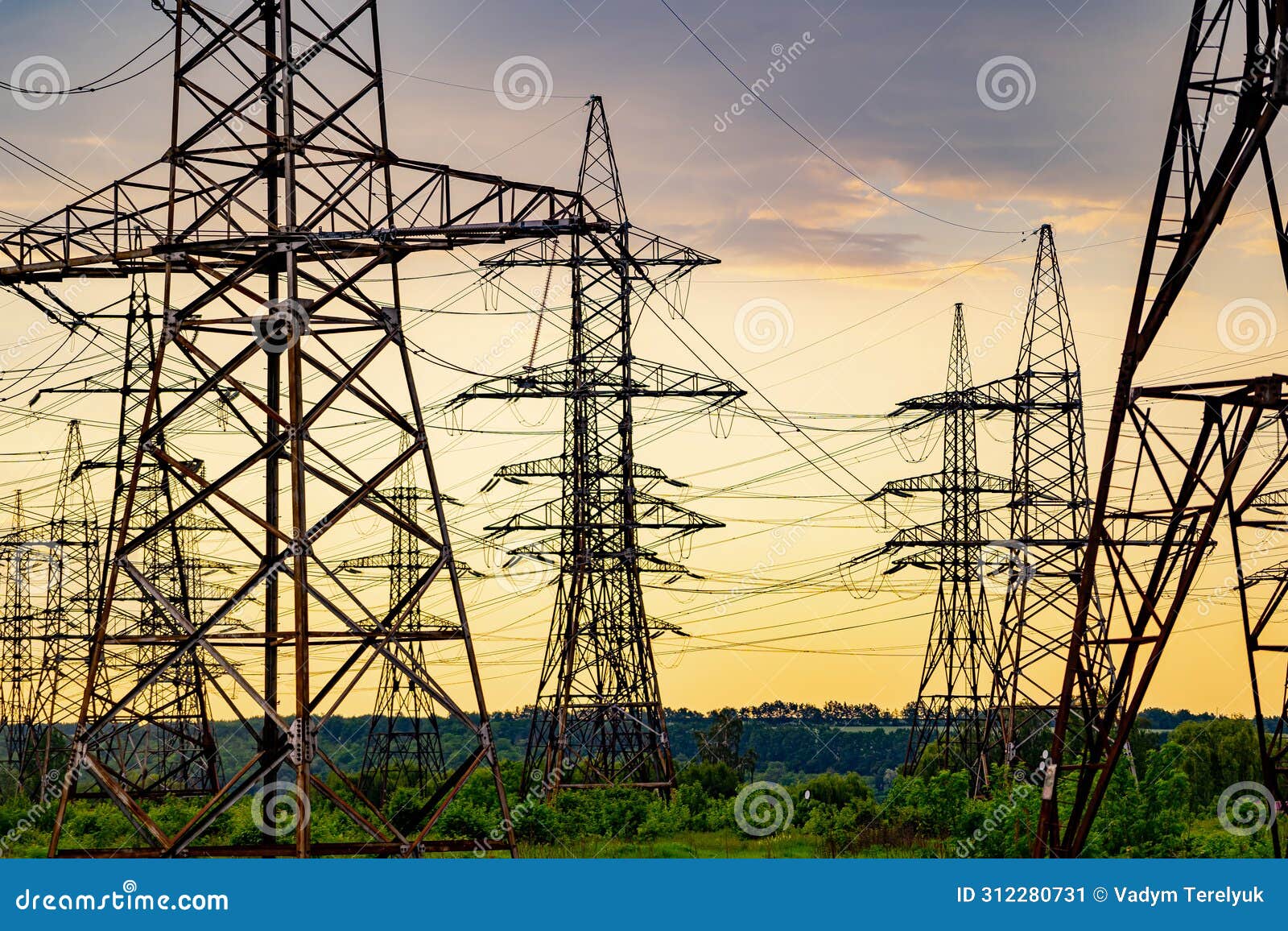 High Voltage Electrical Substation Over Sunset Background with ...