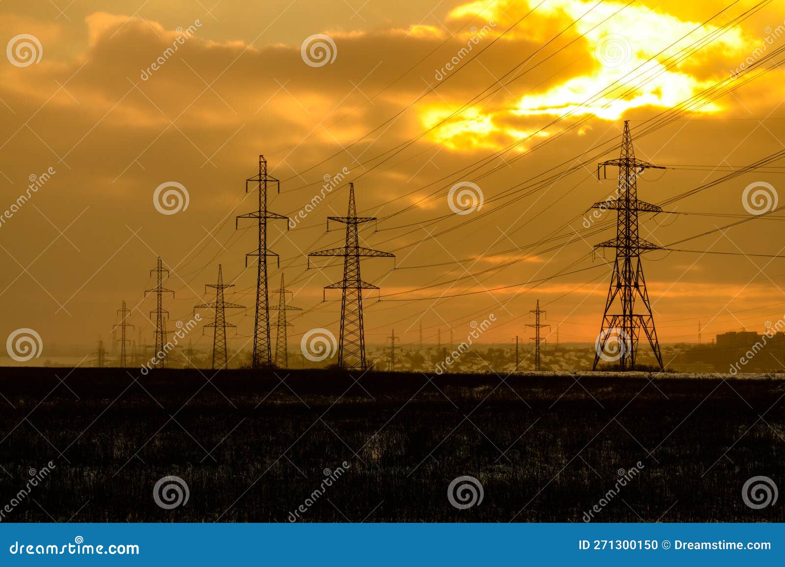 High Voltage Power Line in a Field at Sunset on Winter Stock Photo ...