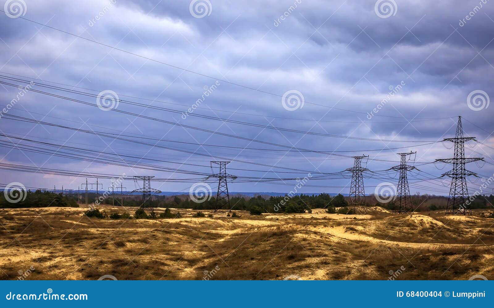 High-voltage Power Line in the Sand in Stormy Weather Stock Photo ...