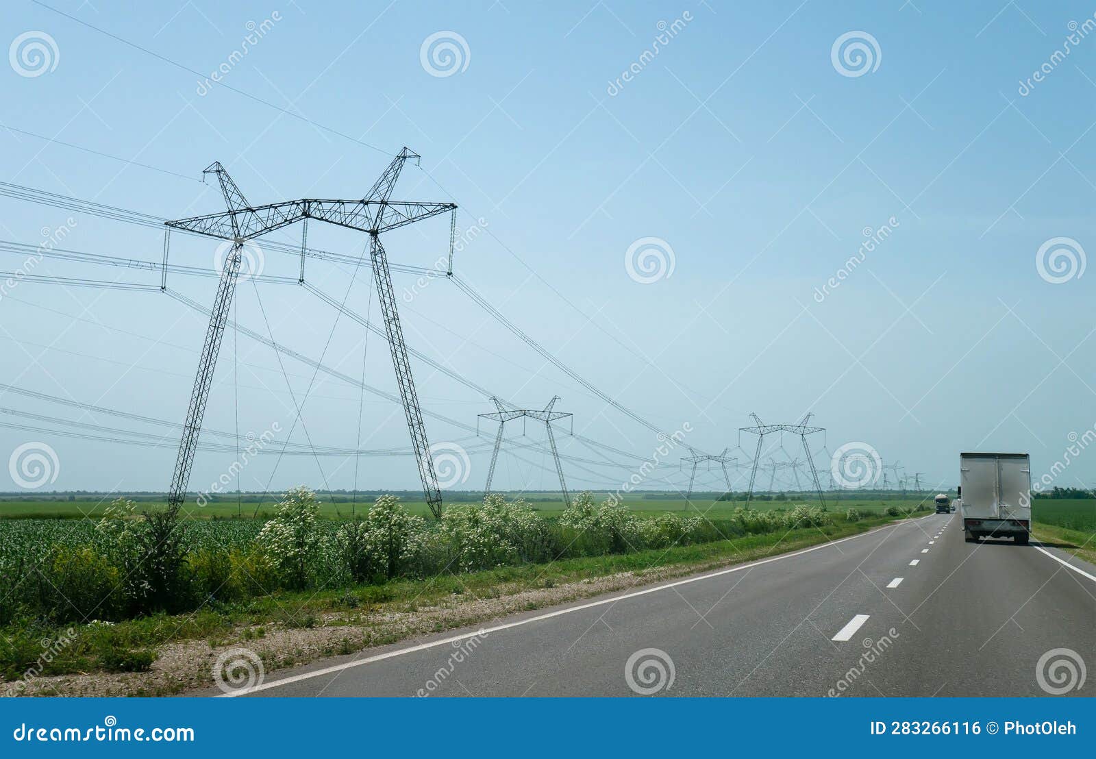 High Voltage Power Lines in a Field Along a Highway Stock Photo - Image ...
