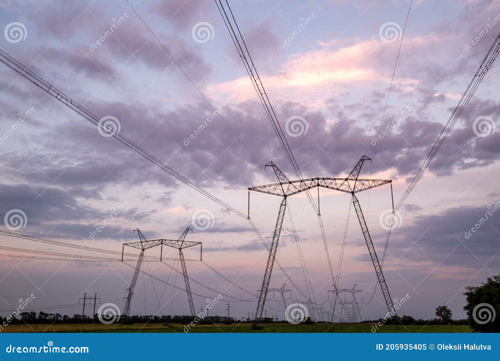 High-voltage Power Lines at Sunset. High Voltage Electric Transmission ...