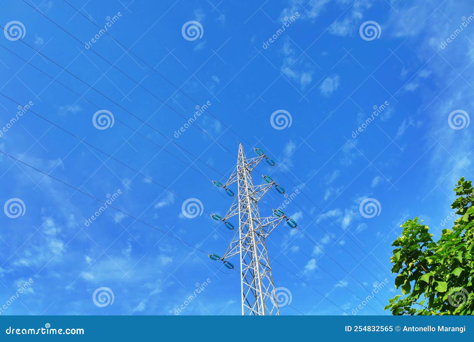 High Voltage Pylon View from Below Under Blue Cloudy Sky Stock Image ...