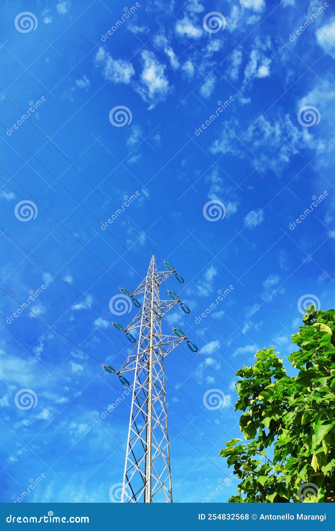 High Voltage Pylon View from Below Under Blue Cloudy Sky Stock Photo ...