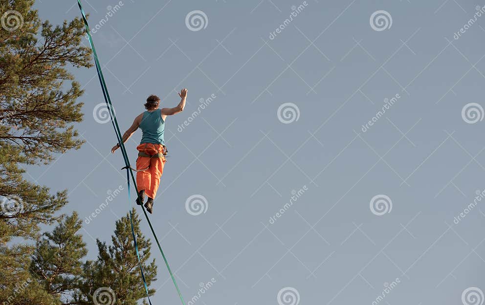 Highliner Walks on a Tightrope Against the Backdrop of the Sky Stock ...