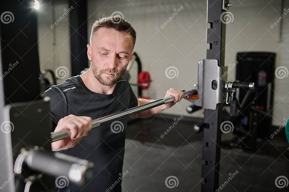 Man Using Smith Machine stock image. Image of resident - 332515903
