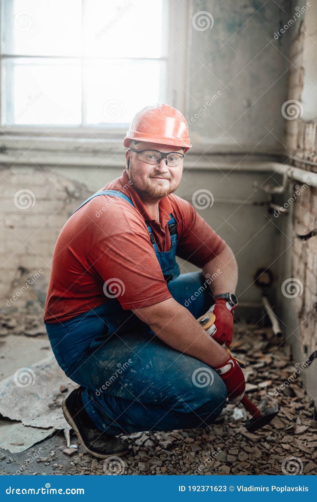 Smiling Builder on a Construction Site Working on a Brick Wall with a ...