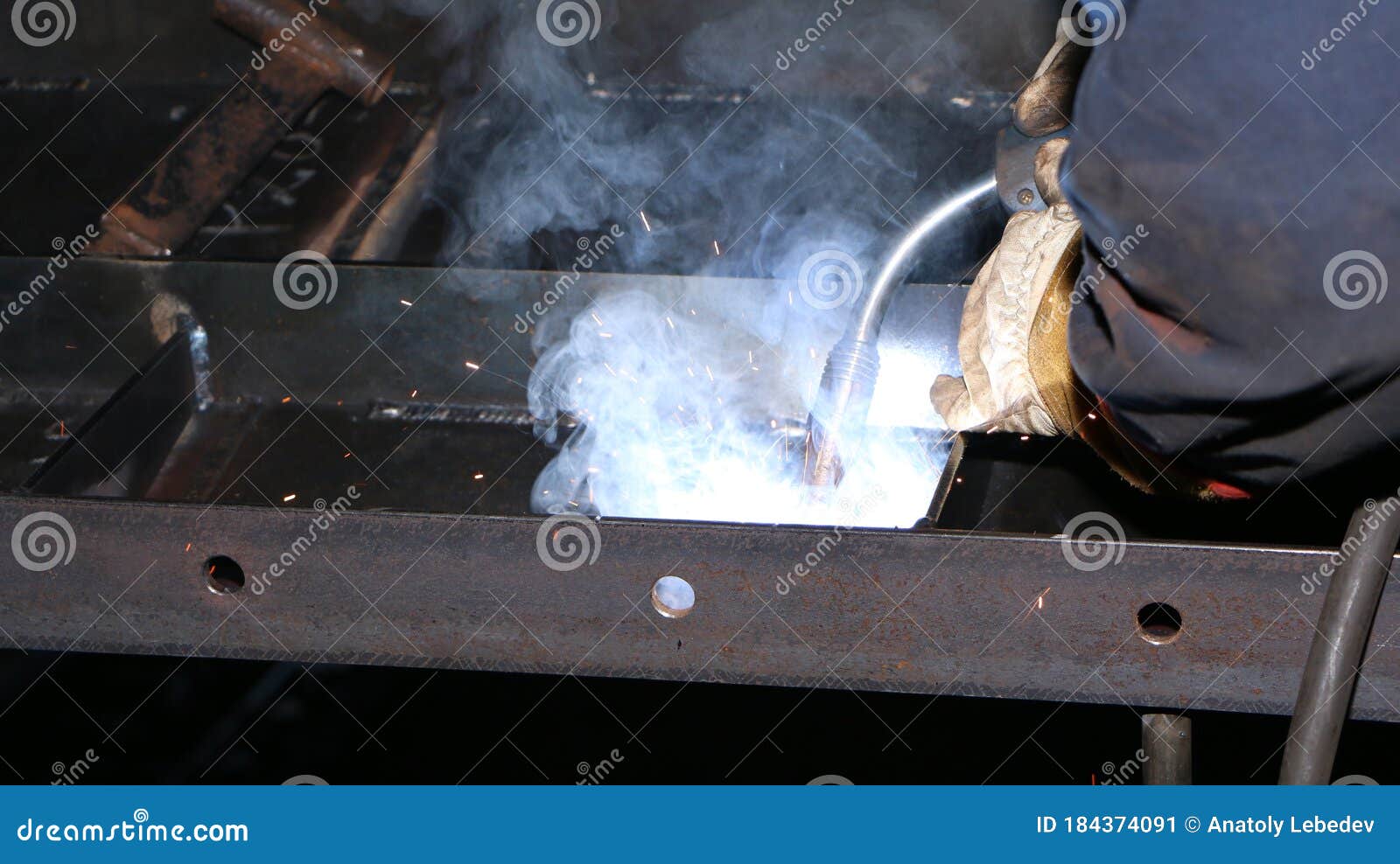 A Highly Skilled Welder Welds a Metal Structure at an Assembly Plant ...