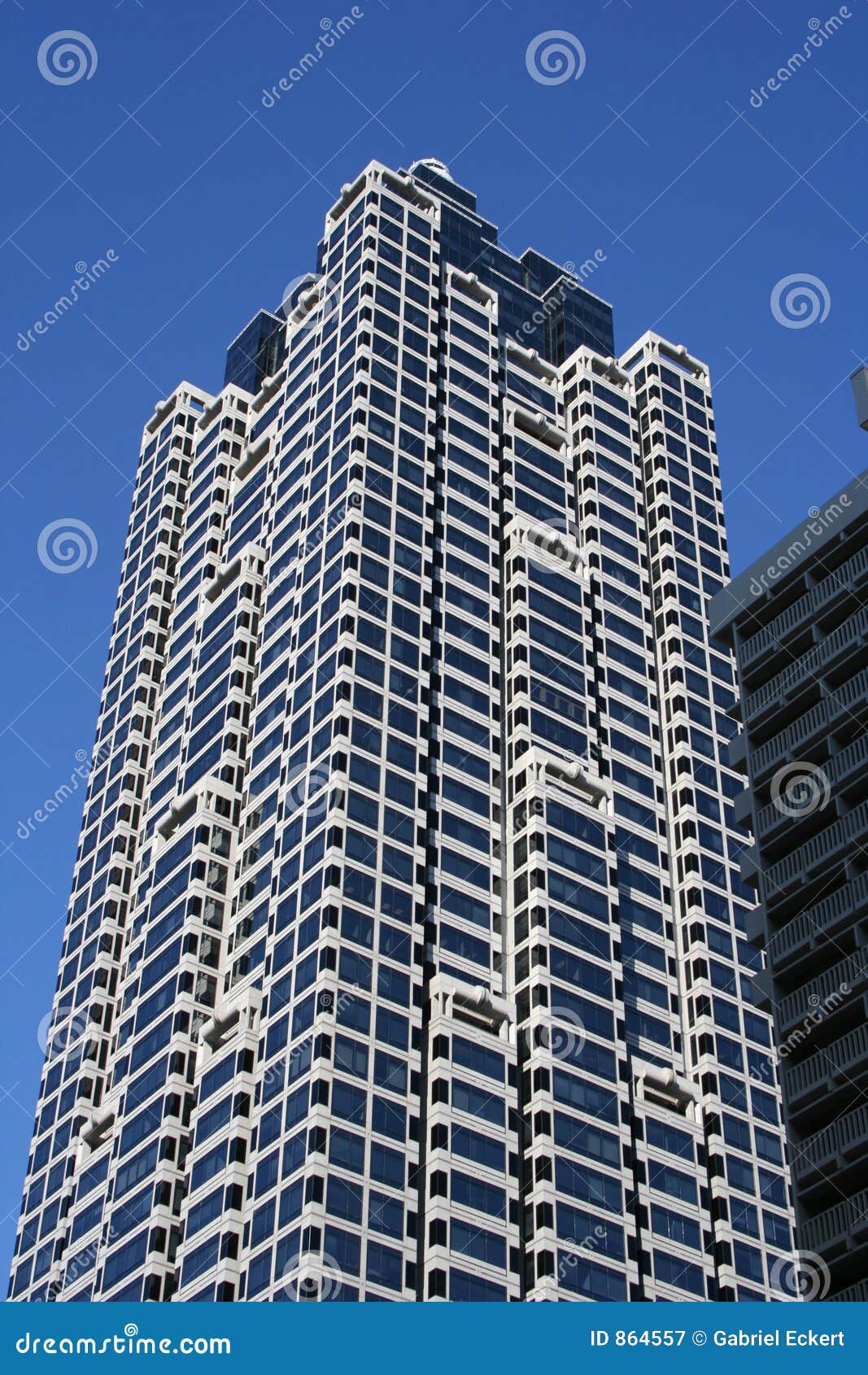 Highrise Building Peaking Over Vegetation At Sunset With Clouds Royalty ...