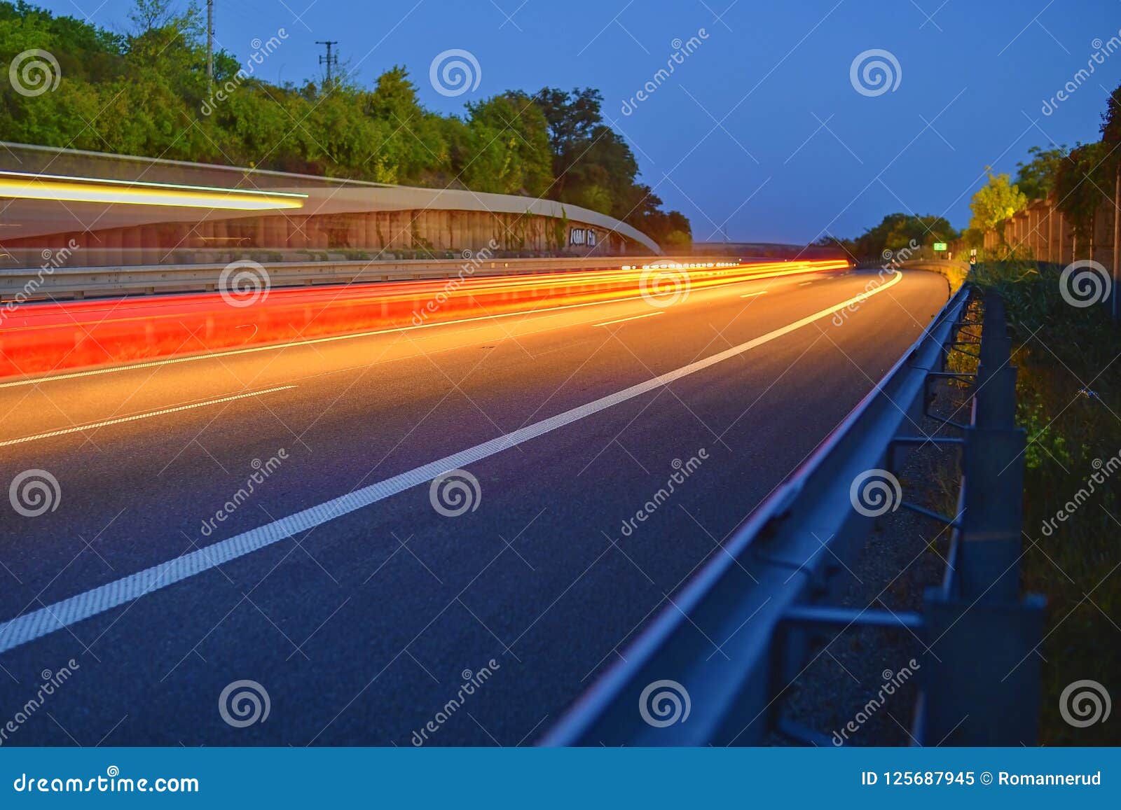 Highway at Twilight with Light Trails. High Traffic Road with ...