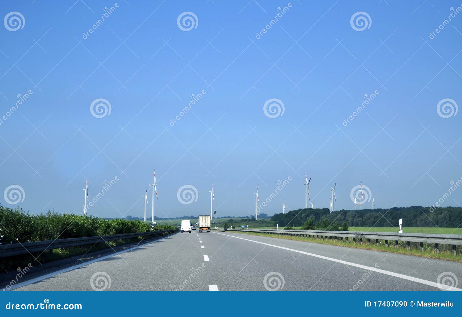 Highway and Wind Turbines in the Foreground Stock Photo - Image of wind ...