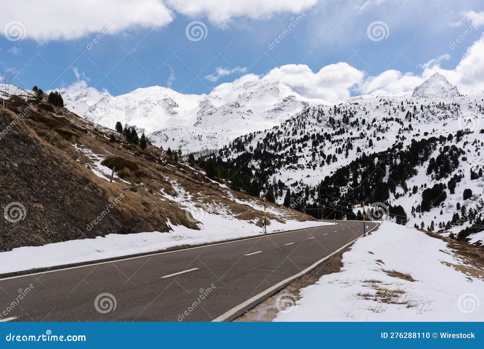 Highway Winding through a Winter Landscape with Snow-capped Rocks and ...