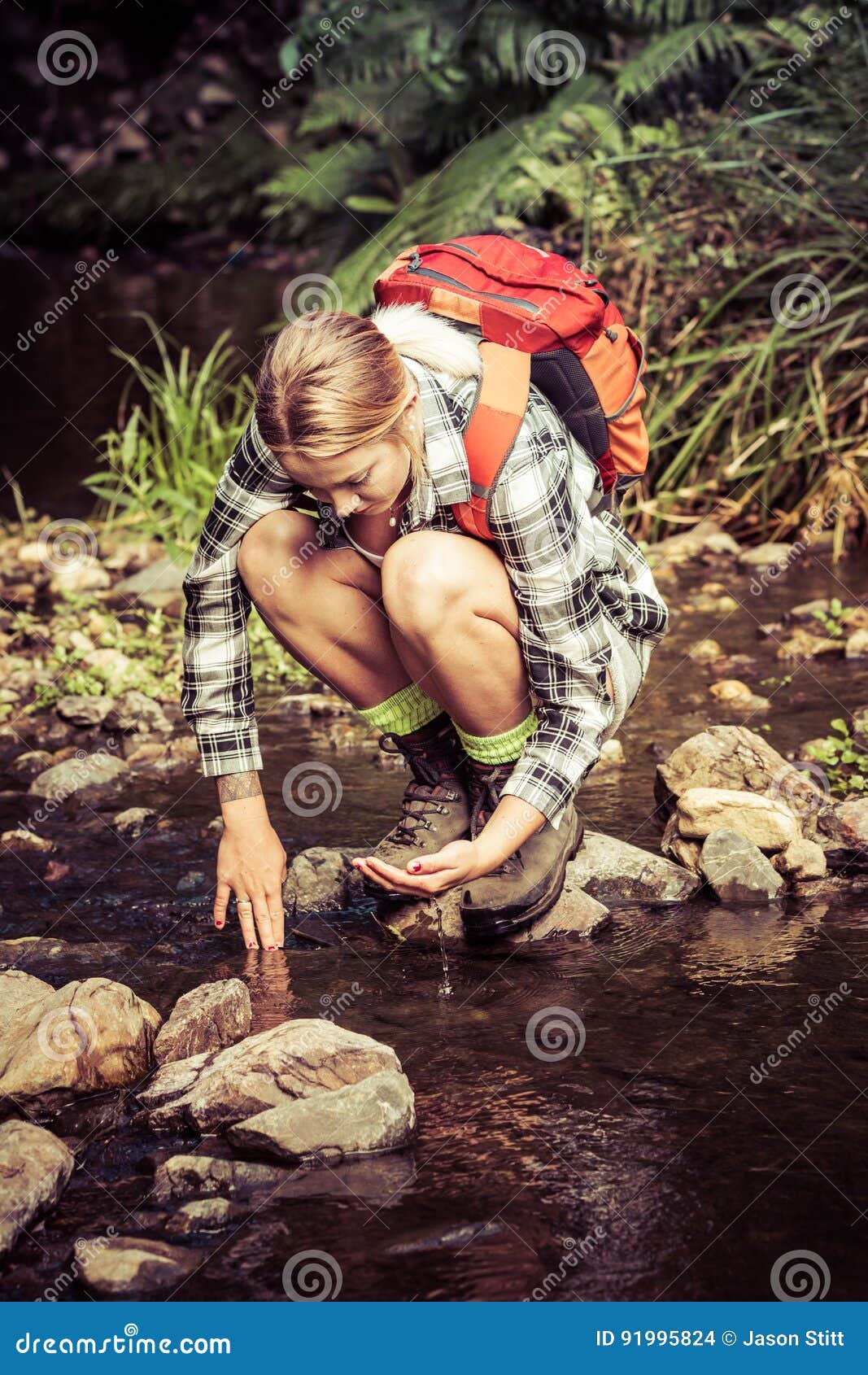 Hiker Drinking from Stream stock photo. Image of bush - 91995824