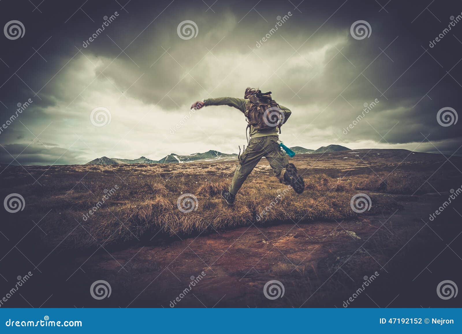 Hiker jumping across river stock photo. Image of mist - 47192152