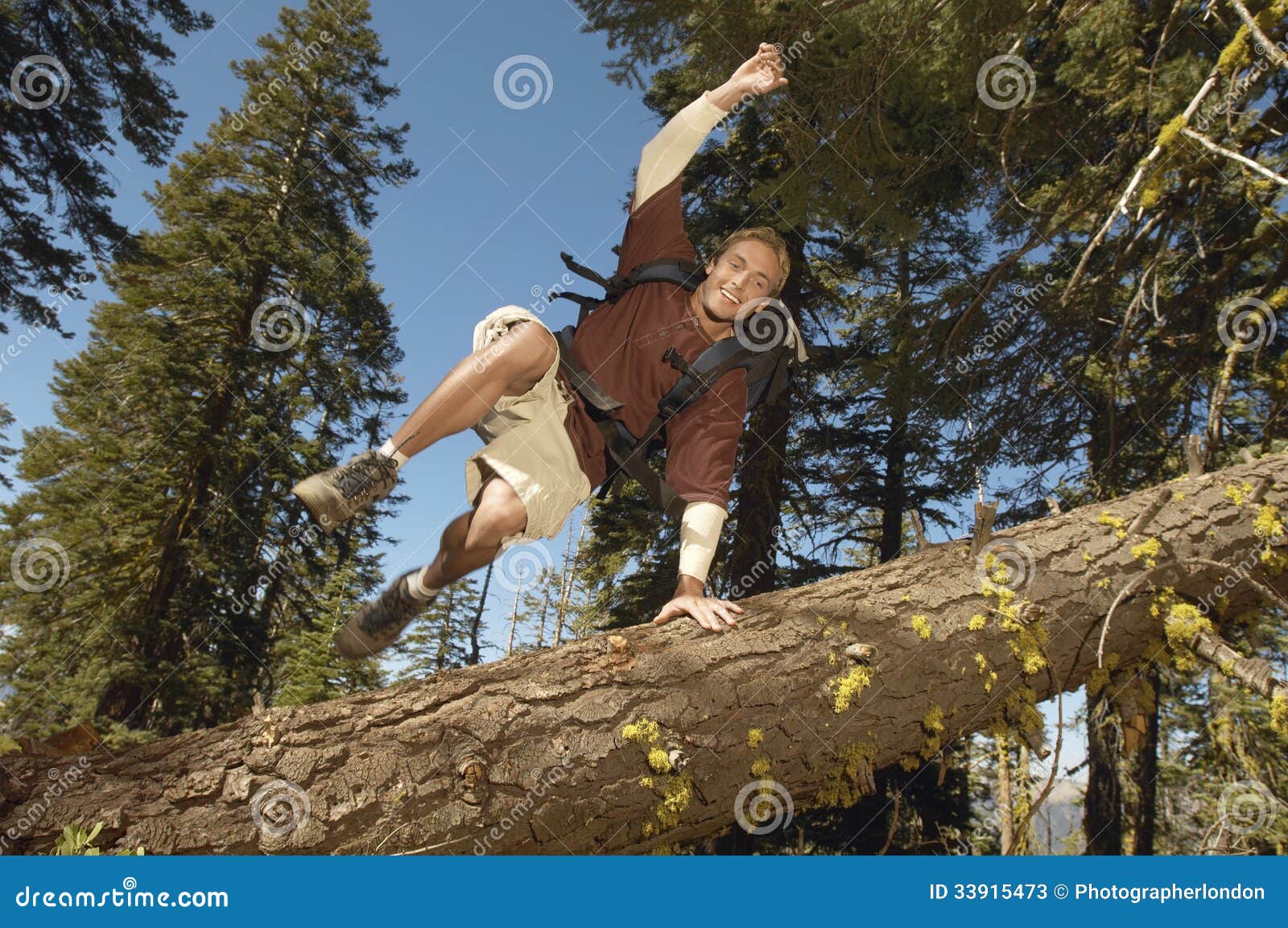 Hiker Jumping Over Fallen Tree in Forest Stock Image - Image of ...