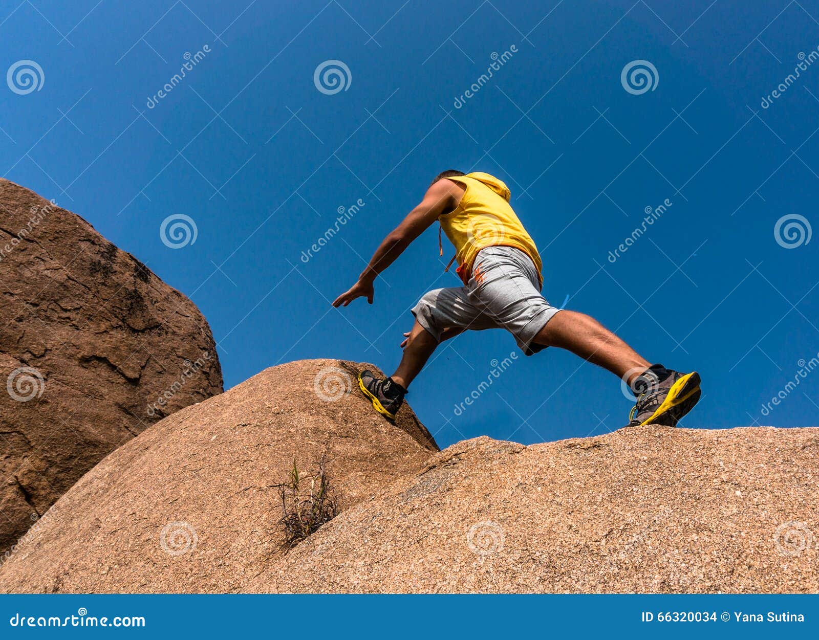 Hiker Jumping Over the Rock Stock Photo - Image of blue, lifestyle ...