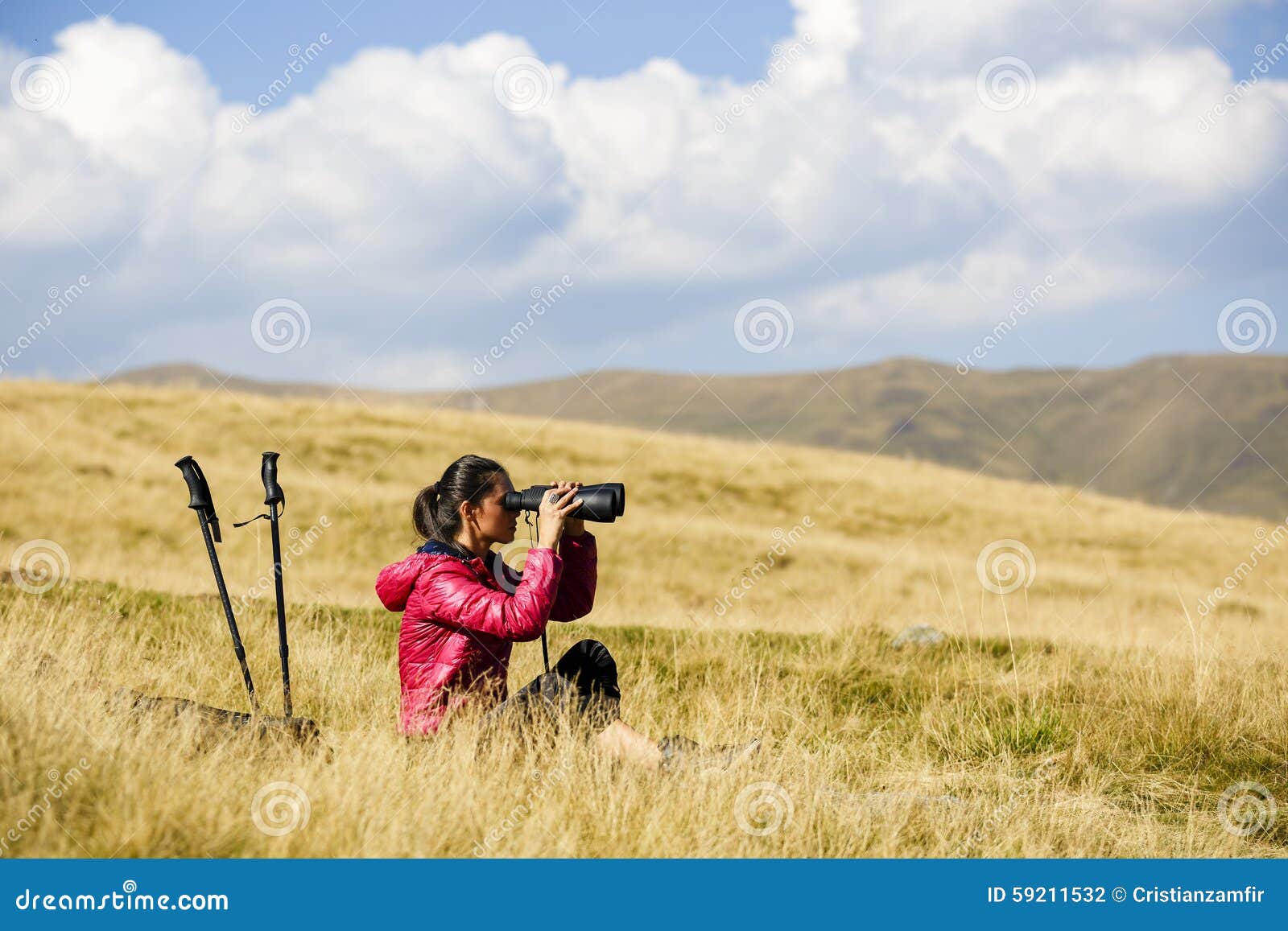 Hiker Looking in Binoculars Enjoying Spectacular View on Mountai Stock ...