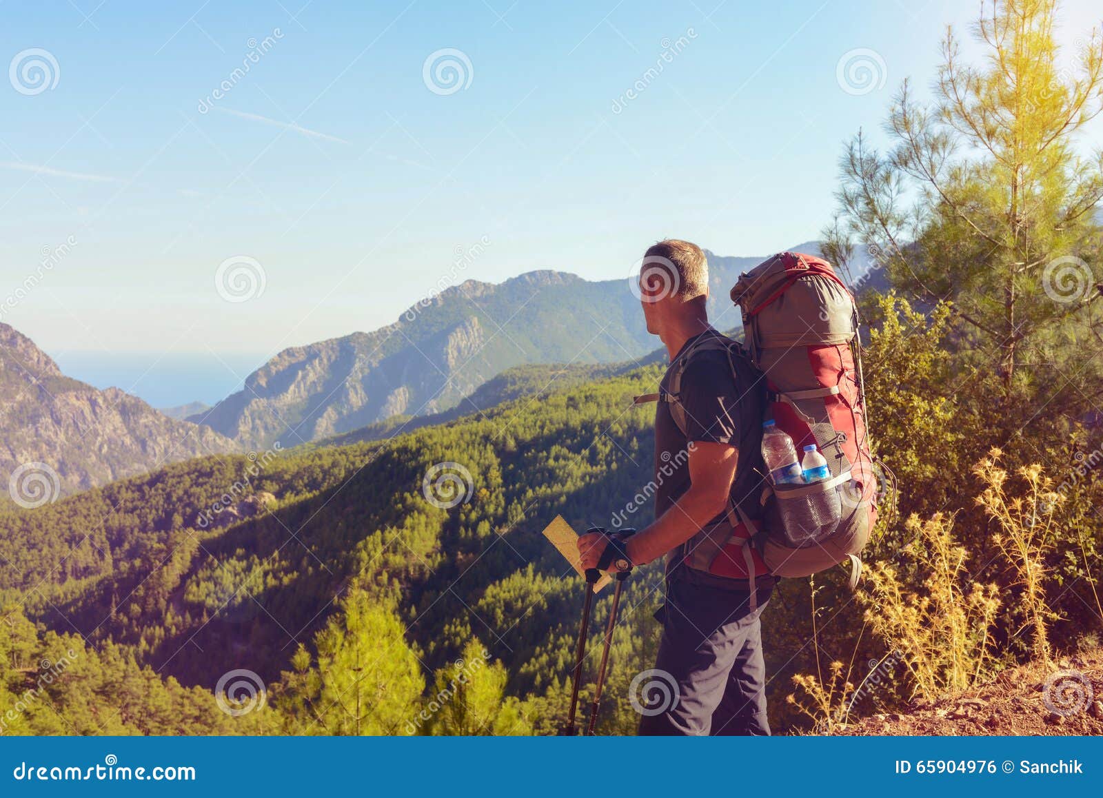 Hiker Man Standing in Mountains and Looking into the Distance. Stock ...