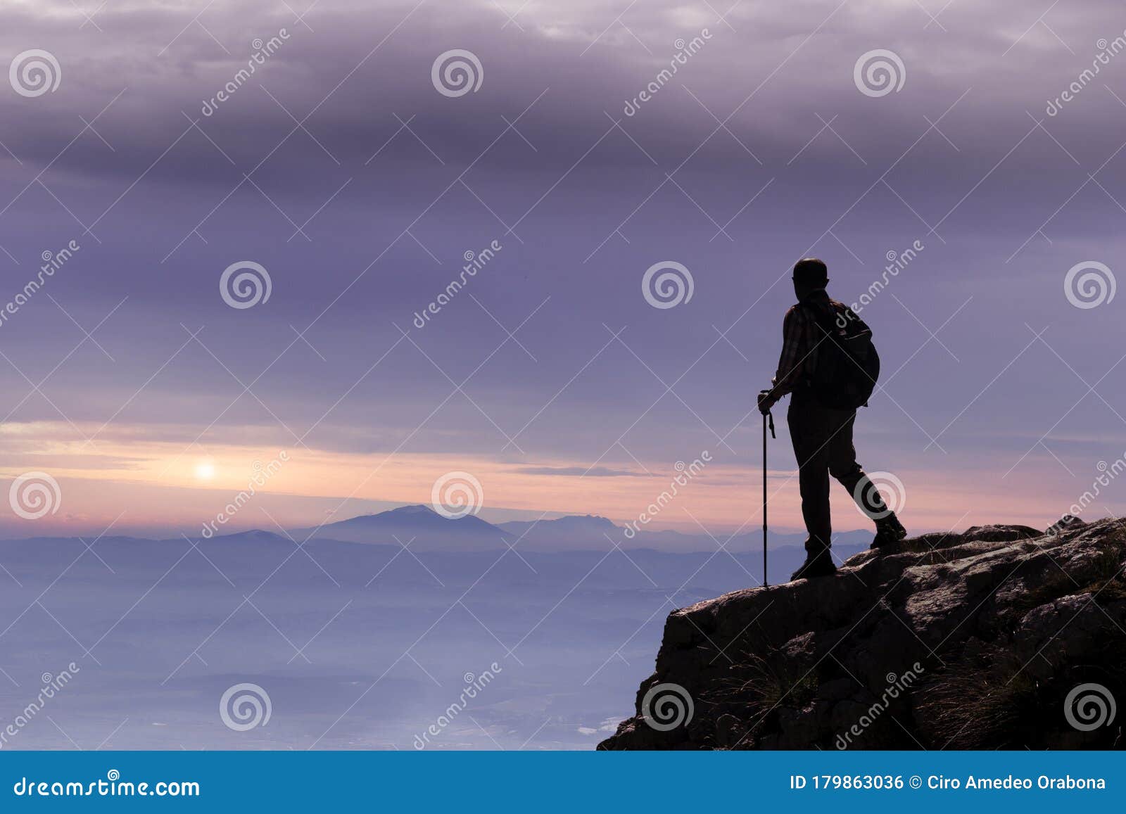 Hiker on mountain peak stock photo. Image of sunset - 179863036