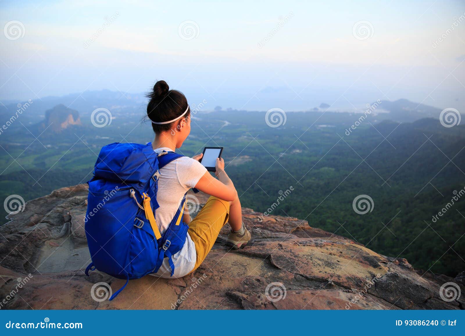 Hiker Reading E-book on Mountain Top Stock Photo - Image of forest ...