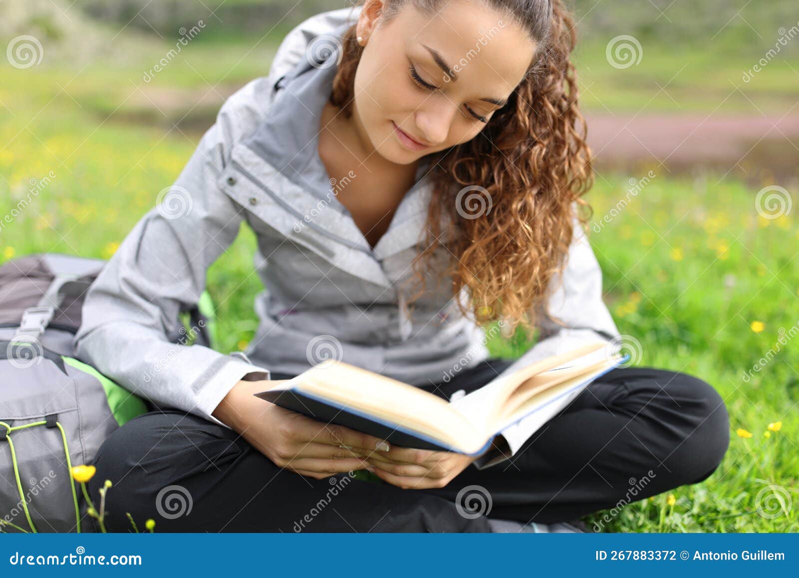 Hiker reading a paper book stock photo. Image of dream - 267883372
