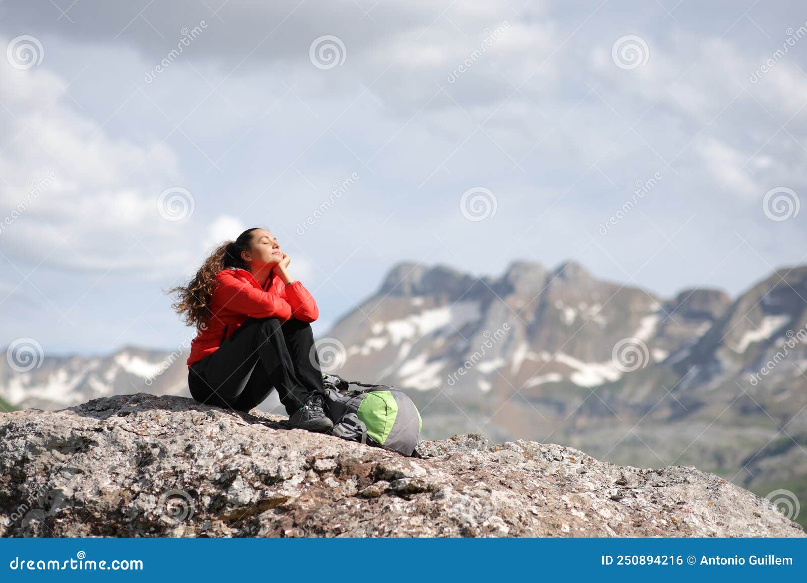 Hiker in Red Resting Sitting in the Top of a Mountain Stock Photo ...