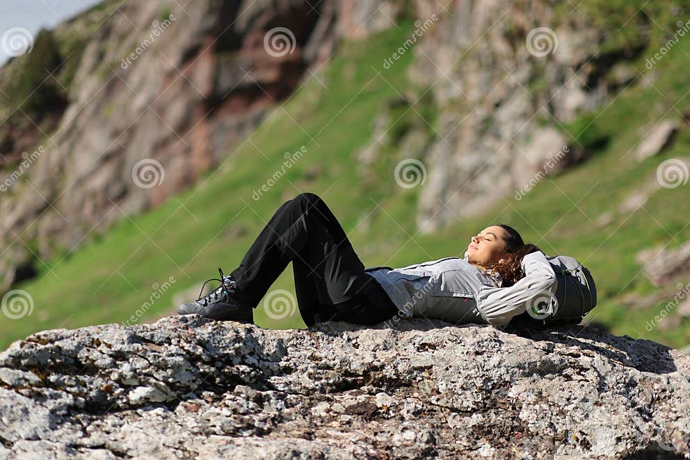 Hiker Resting Lying on a Rock in the Mountain Stock Photo - Image of ...