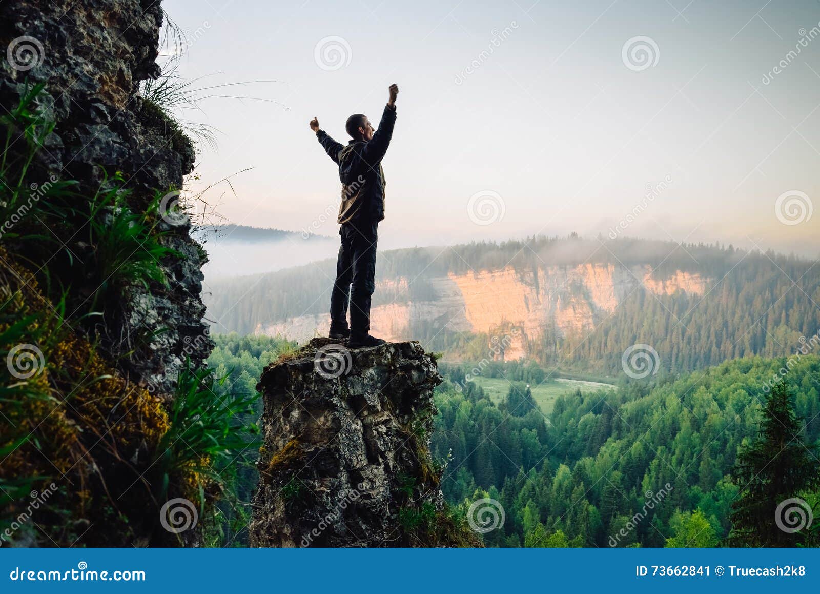 Hiker Stands on Top of the Mountain, Hands Raised Up Stock Image ...