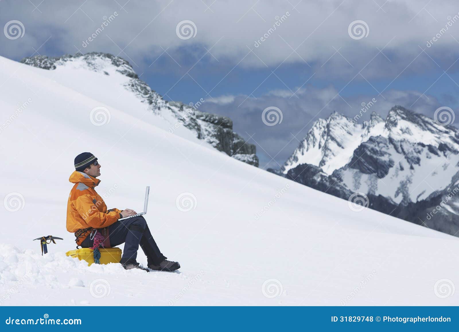 Hiker Using Laptop on Snowy Mountain Slope Stock Photo - Image of ...