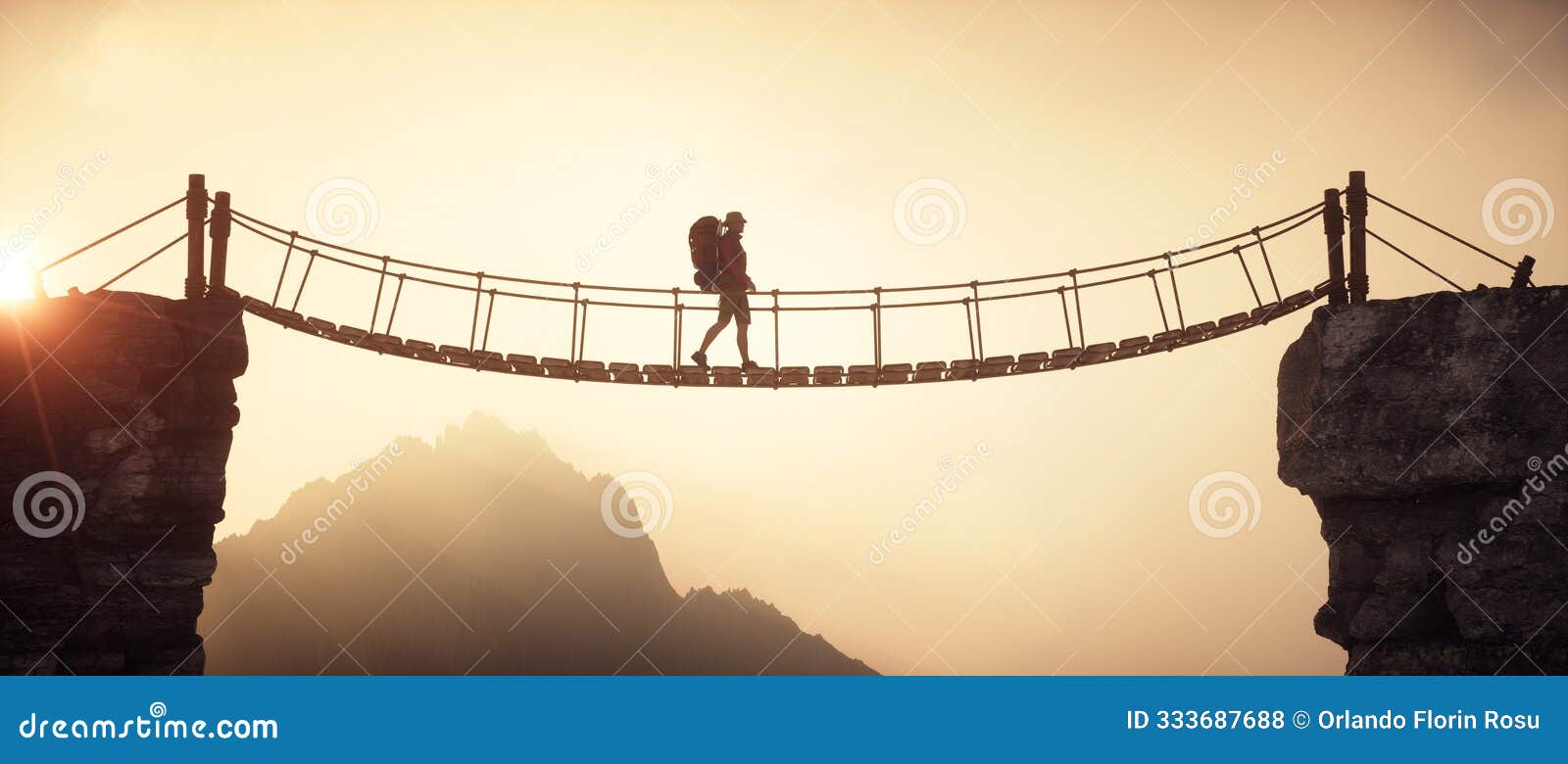 Hiker Walking on a Suspension Bridge between Mountains Stock ...