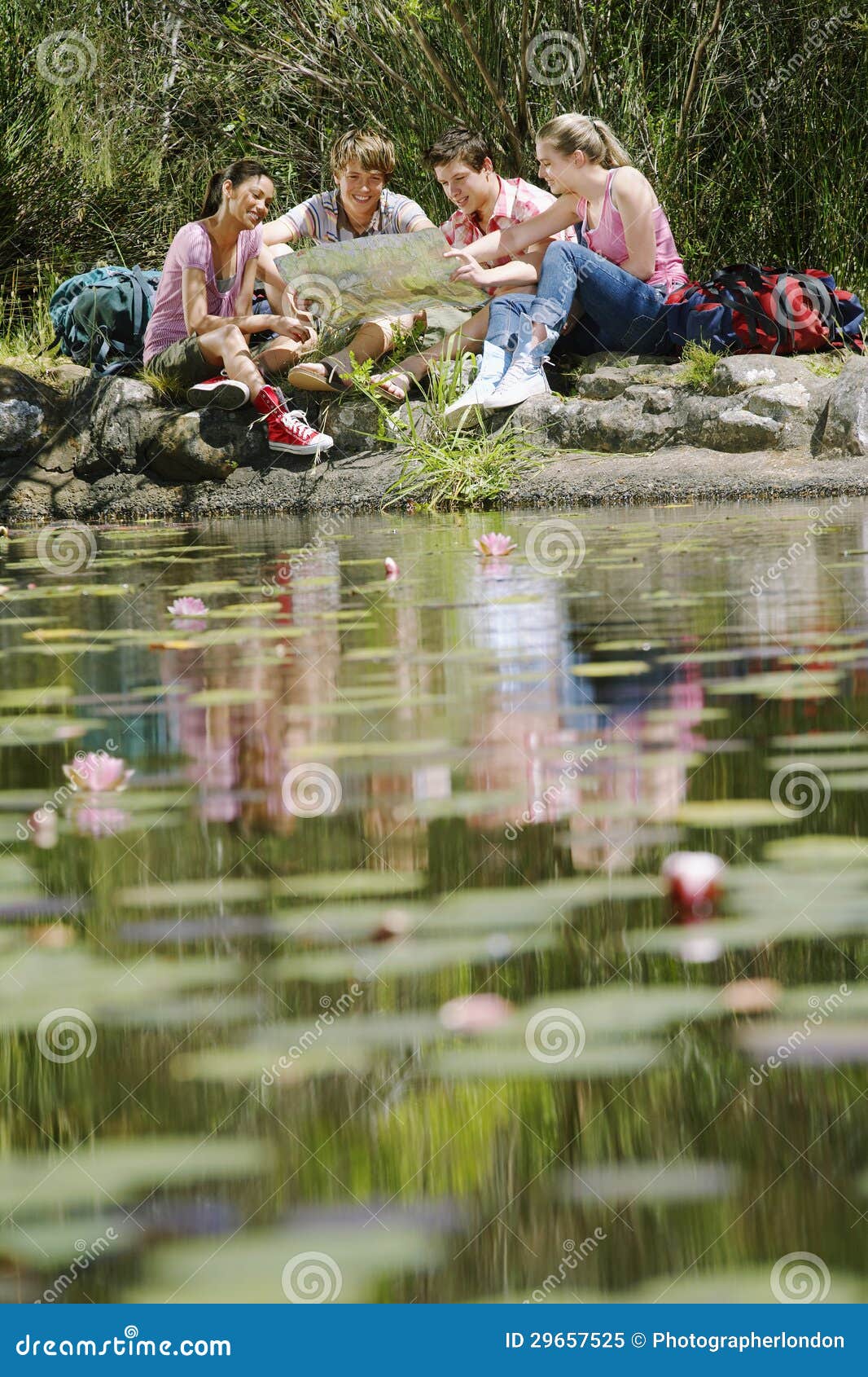 Hikers Reading Map by Lake stock image. Image of guidance - 29657525