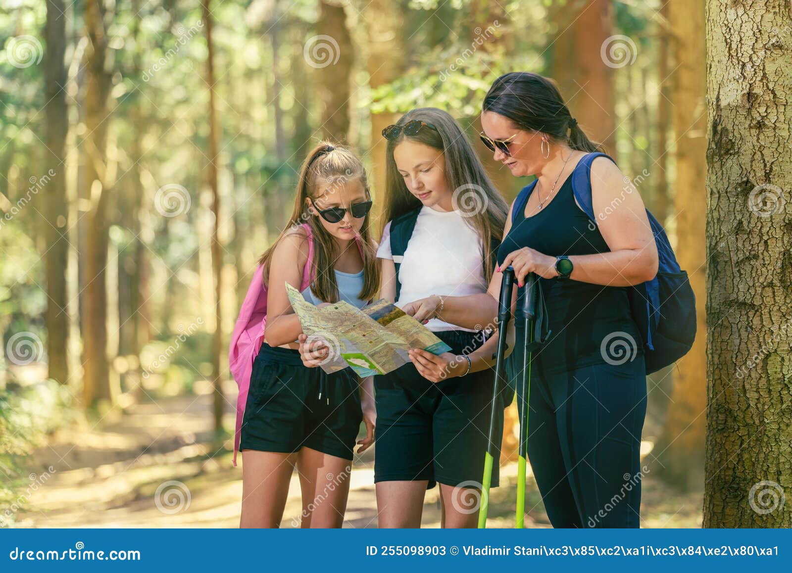 Hikers Study a Paper Map in the Forest Stock Image - Image of girl ...