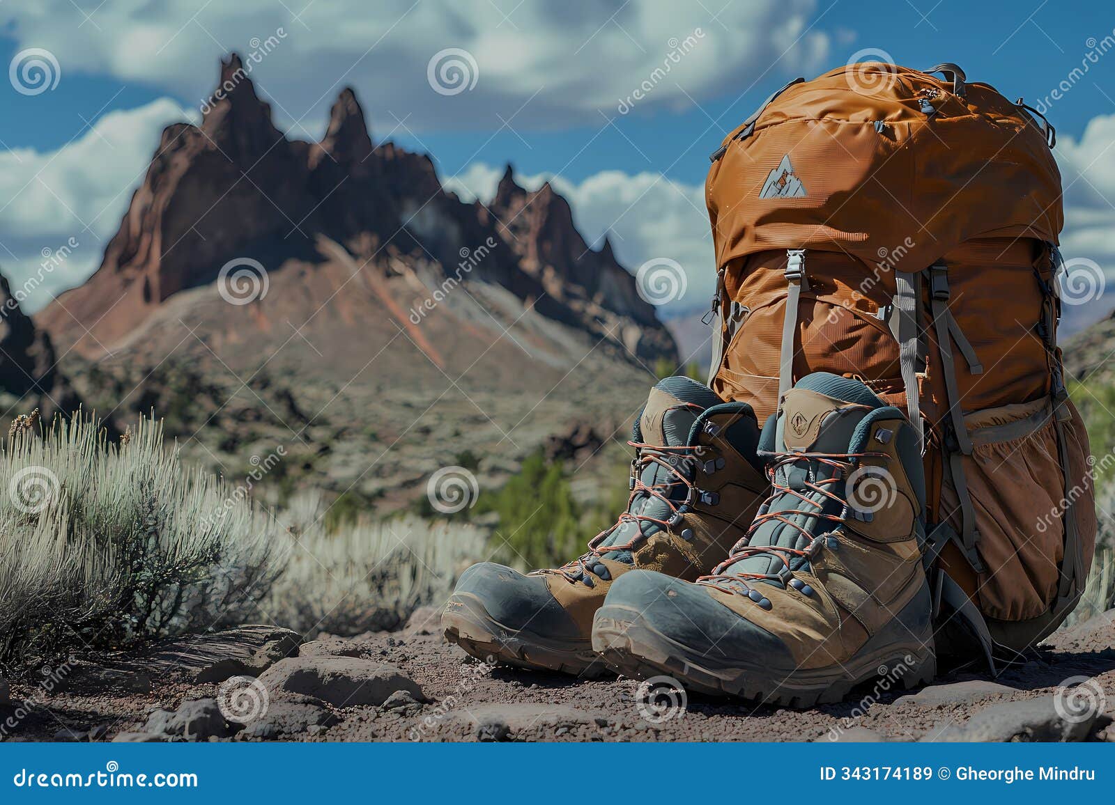 Hiking Boots and Backpack on the Ground with Mountains in the ...