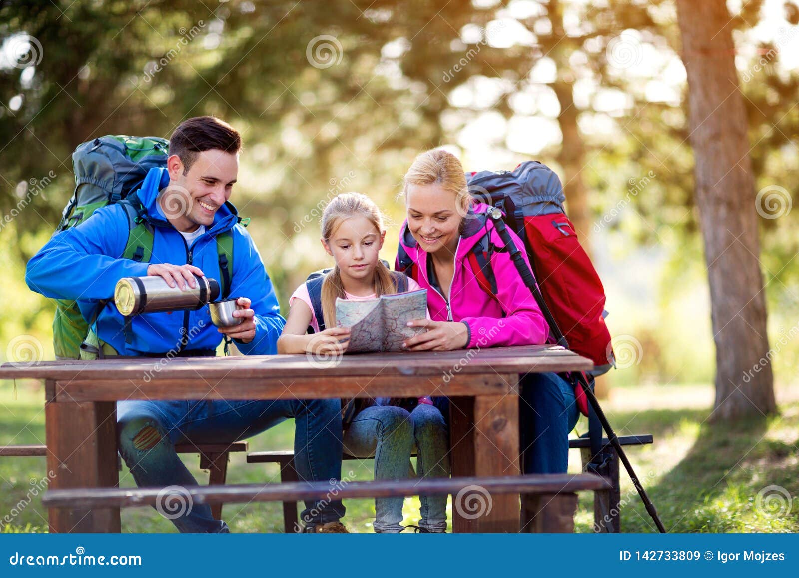 Hiking Family Relax Sitting and Look on the Map Stock Image - Image of ...