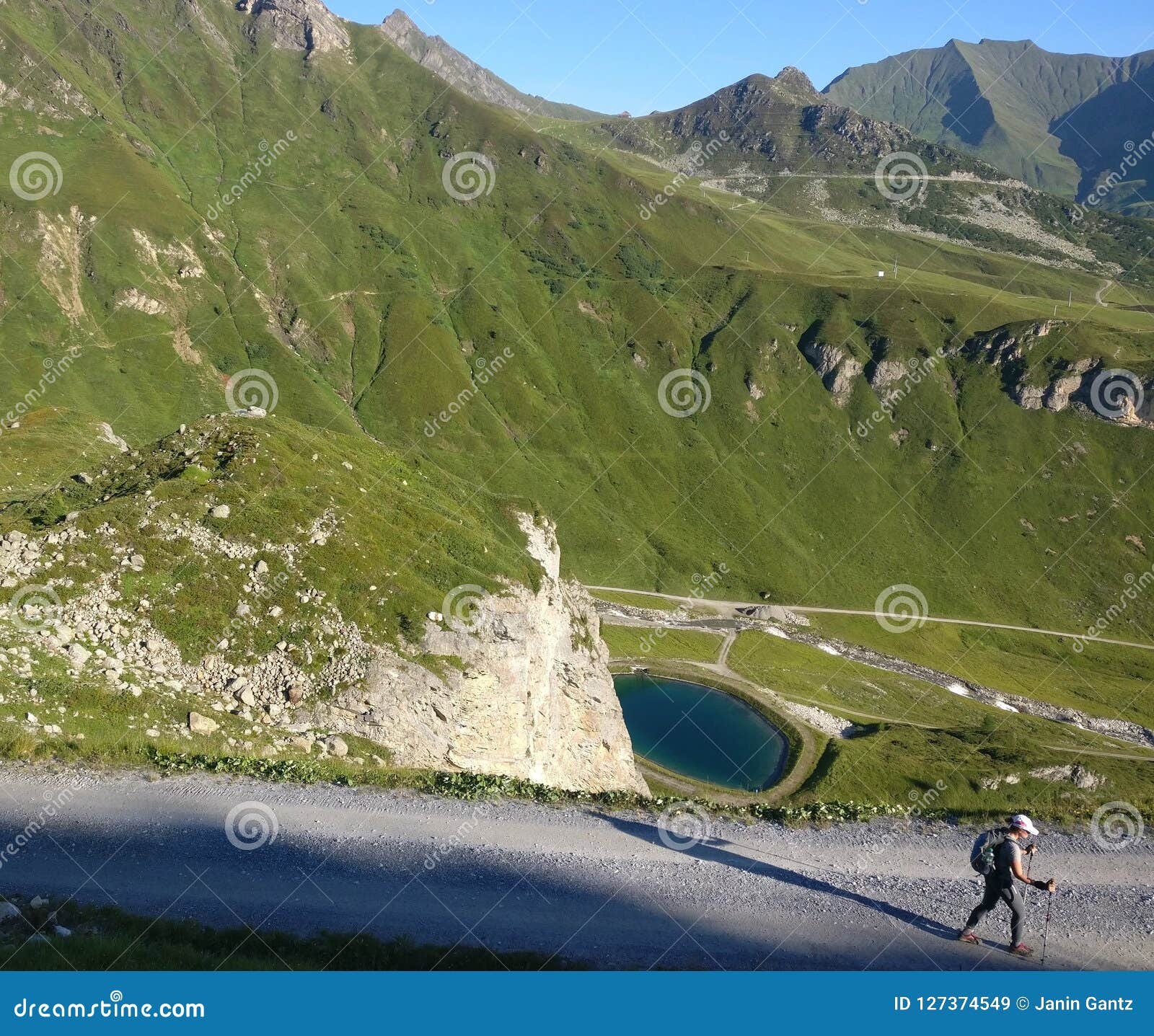 Hiking Girl Walking a Path in the Mountains with a Long Shadow Stock ...