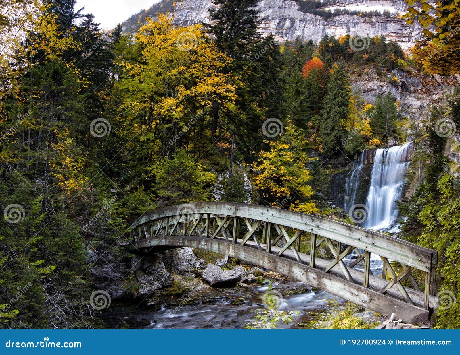 Hiking Over a Bridge by a Waterfall in the French Alps Stock Photo ...