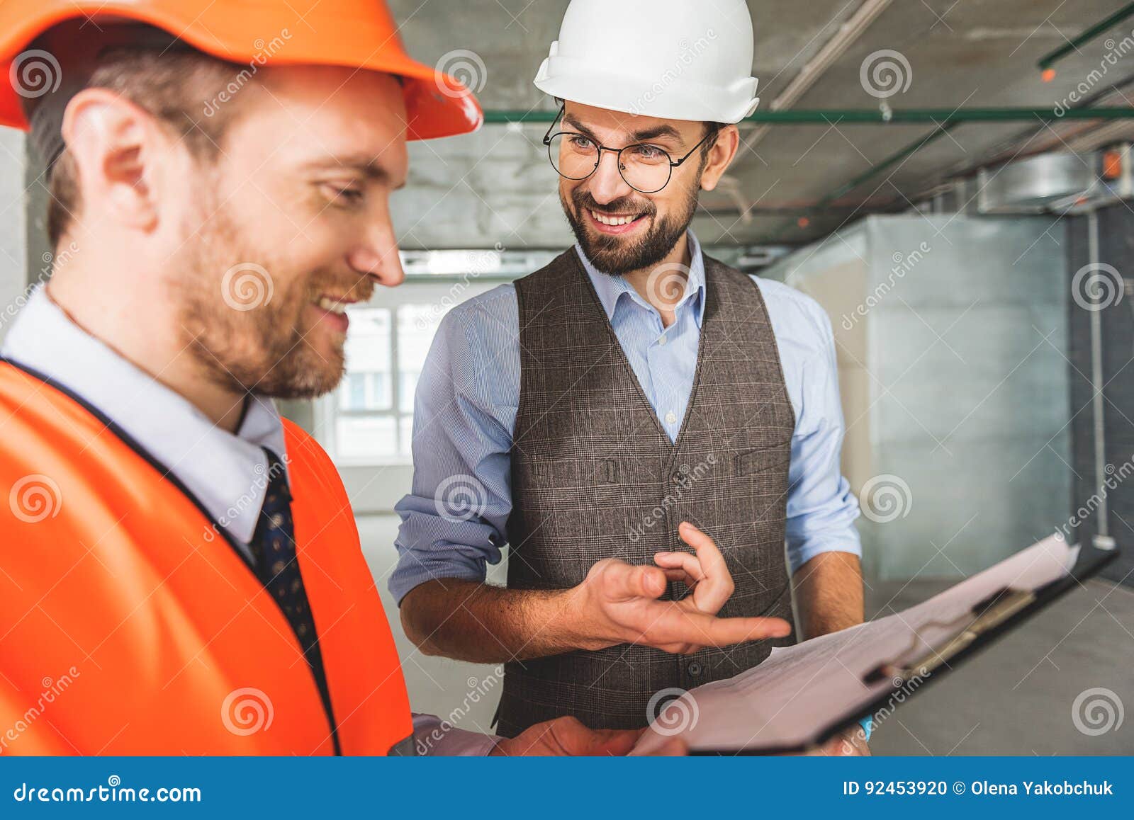 Hilarious Contractor Standing beside Colleague Stock Photo - Image of ...