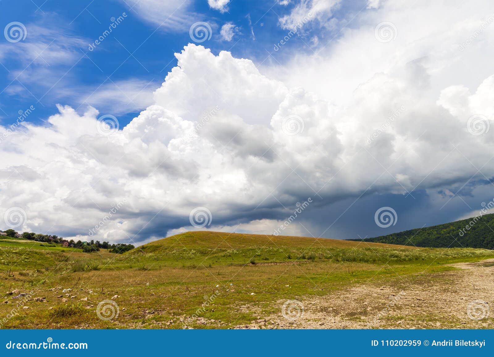 Hill with Green Grass and Dramatic Storm Clouds Overhead Stock Image ...