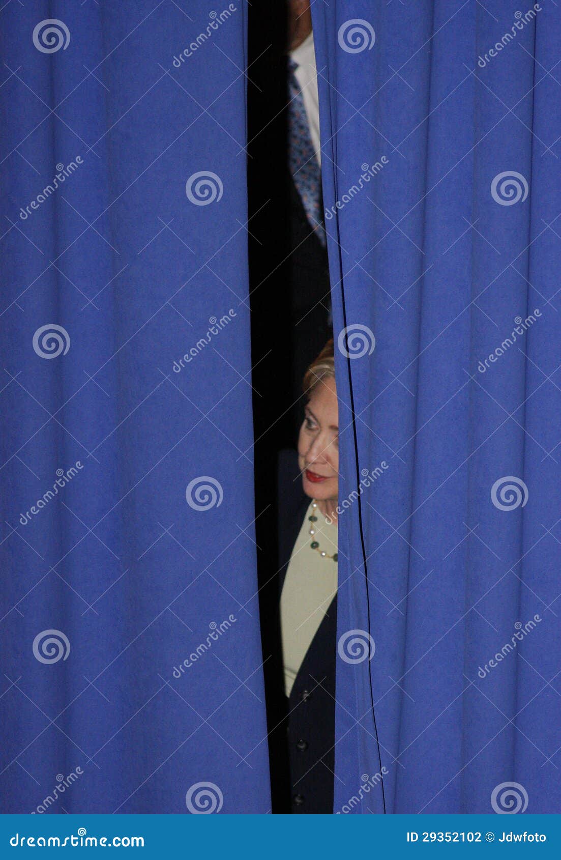 Hillary Clinton Peaking Out from Behind Blue Curtains. Editorial ...