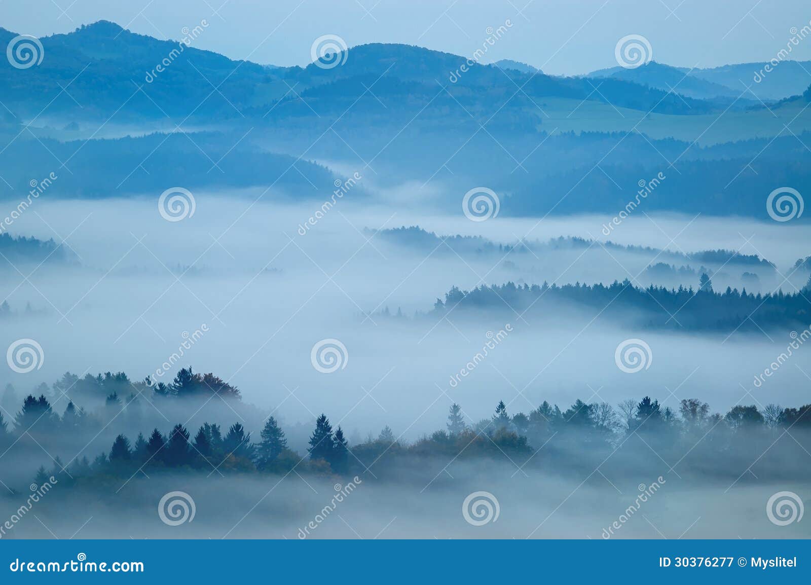 Hilly landscape with fog stock image. Image of forest - 30376277