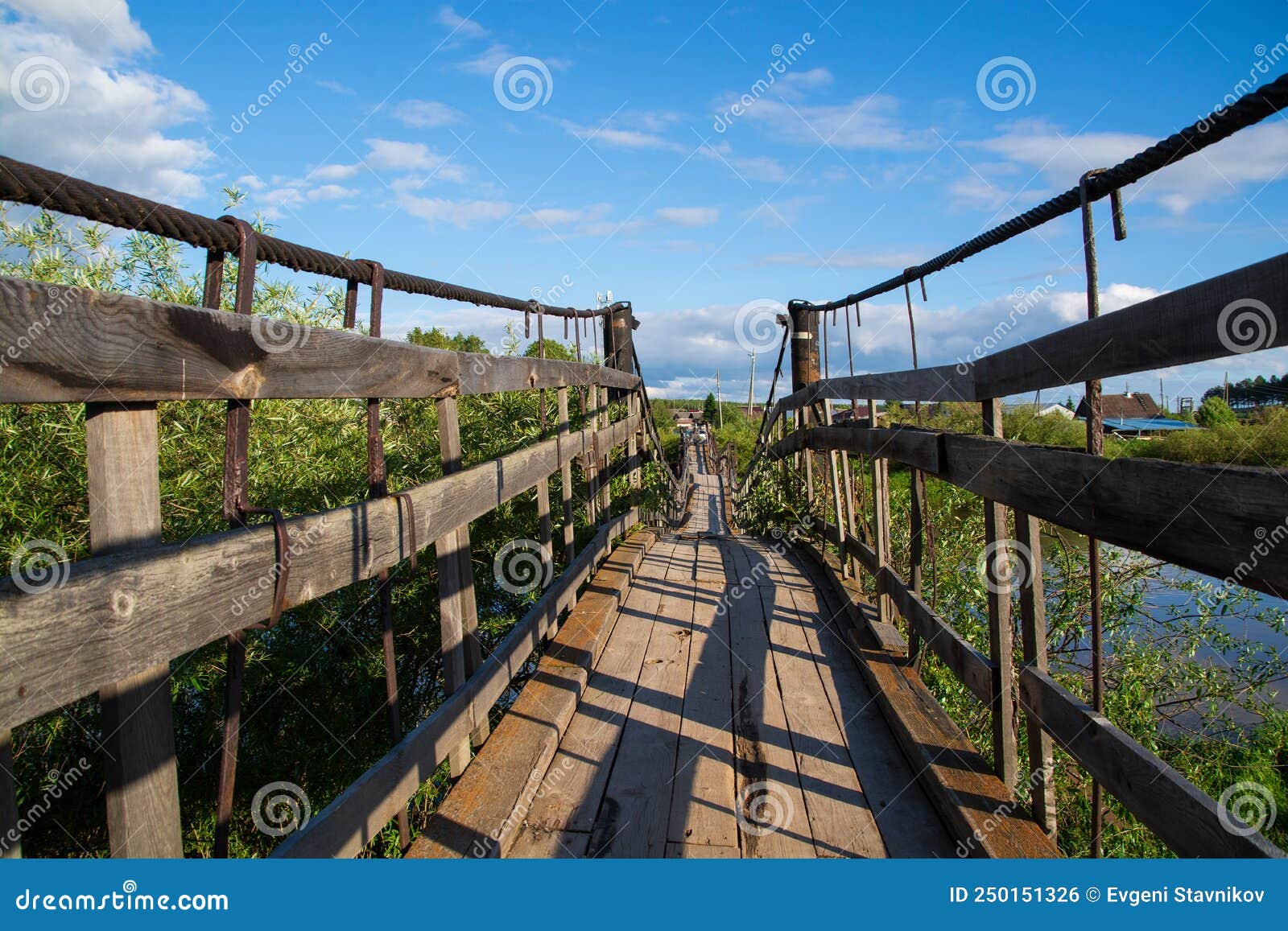 Hinged Wooden Bridge Across the River into the Forest. Stock Photo ...